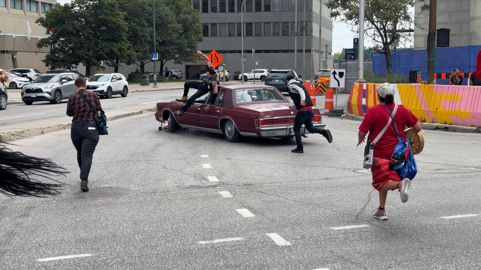 Car drives through police protest in Winnipeg, driver confronted